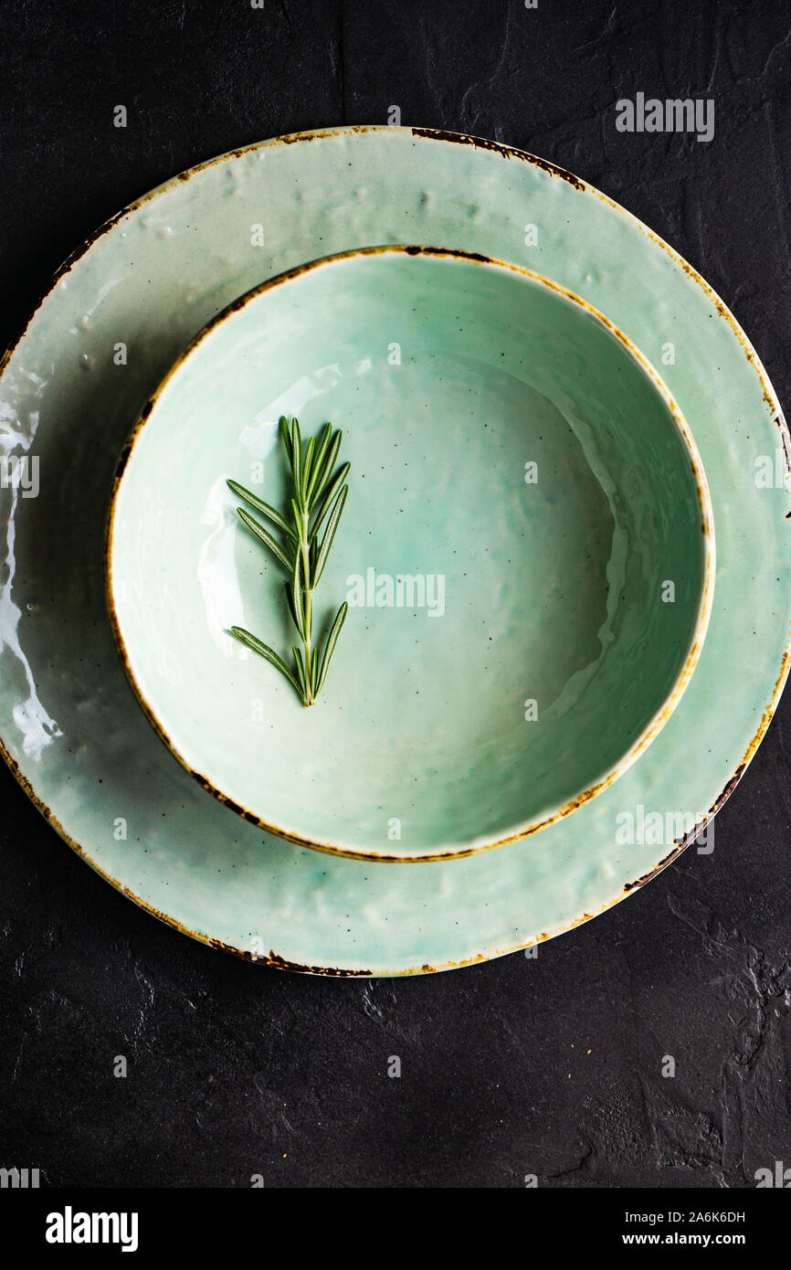Rustic table setting with cutlery and plates decorated with fresh ...
