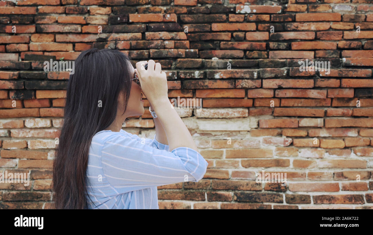Young traveller girl exploring tourist attractions and taking photos ...