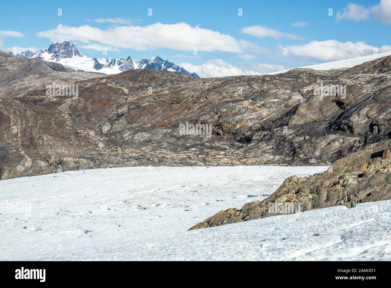Melting Glacier revealing layered bedrock below a remote Canadian Peak ...
