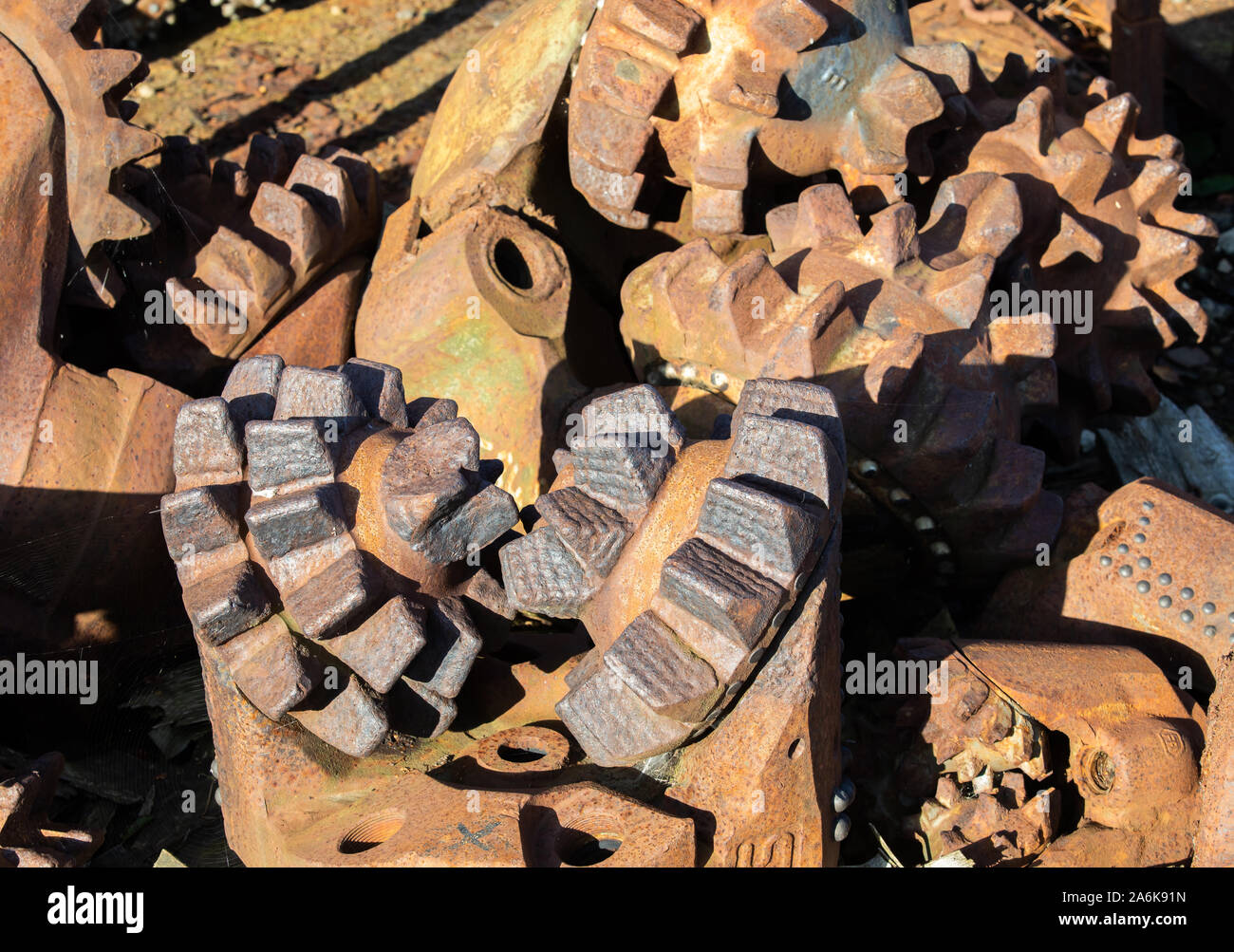 Old rusty oil rig drill bits in a yard Stock Photo - Alamy