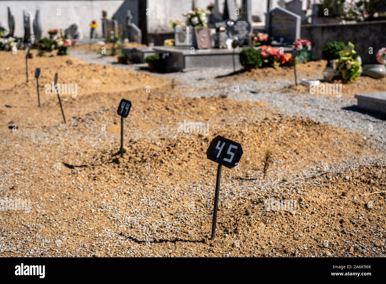 Markers for the positioning of new grave plots in the ground in a ...