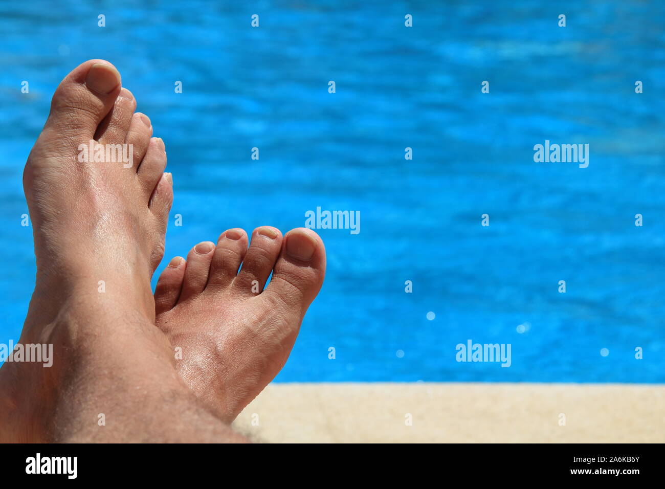 young man is lying by the pool Stock Photo - Alamy
