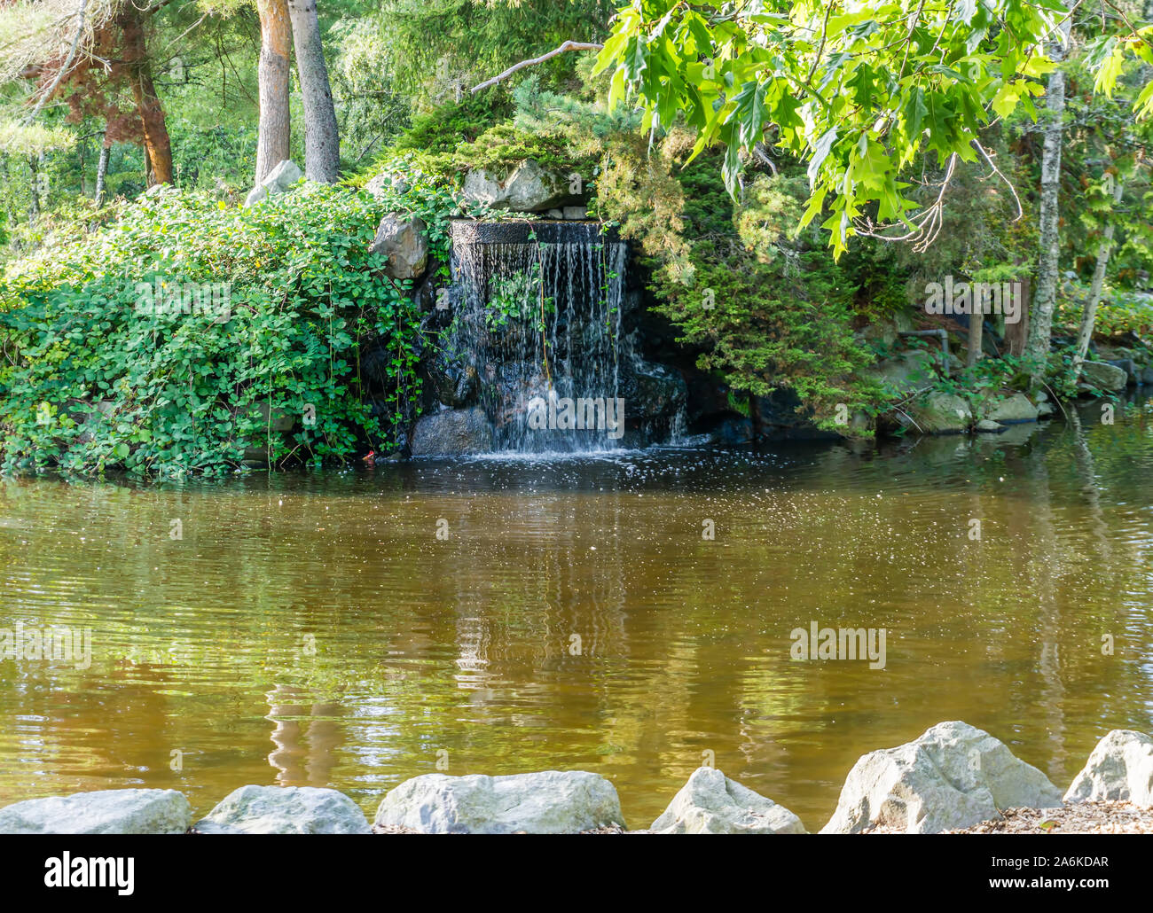 A watertall flows into a pond at Point Defiance Park in Tacoma ...