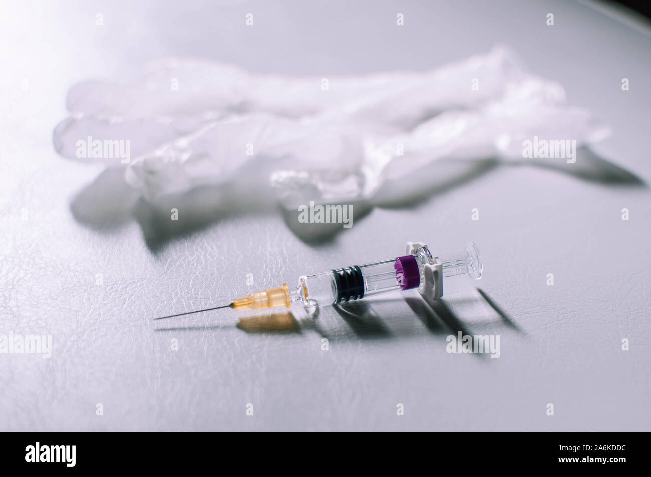 Medical syringe and gloves on a white background Stock Photo - Alamy
