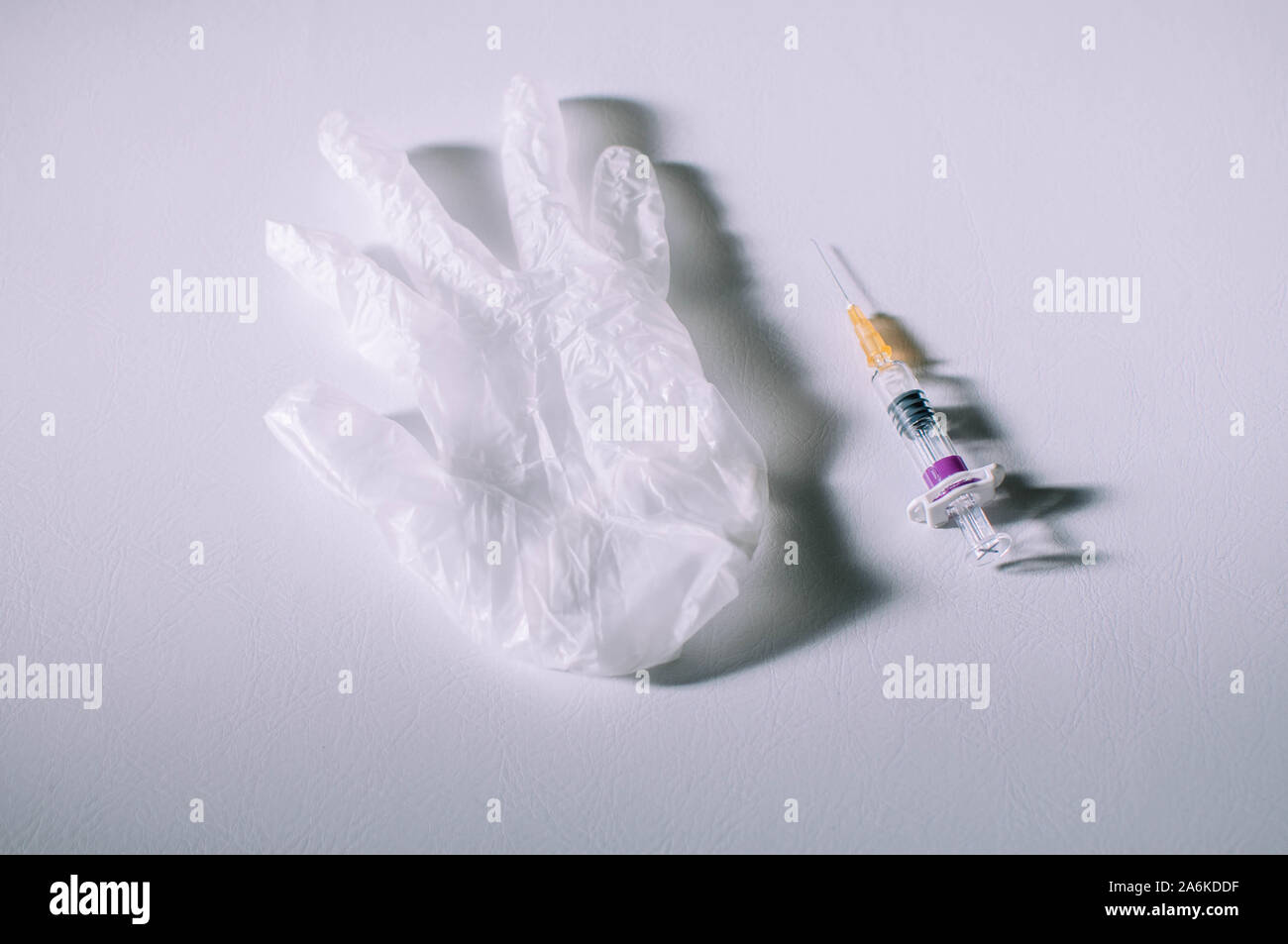 Medical syringe and gloves on a white background Stock Photo - Alamy