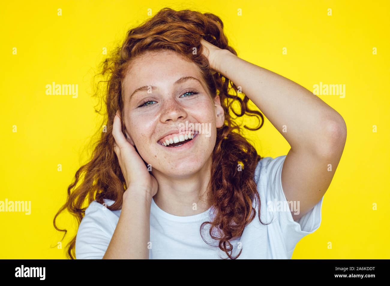 Portrait Of Beautiful Cheerful Redhead Girl With Curly Hair Smiling