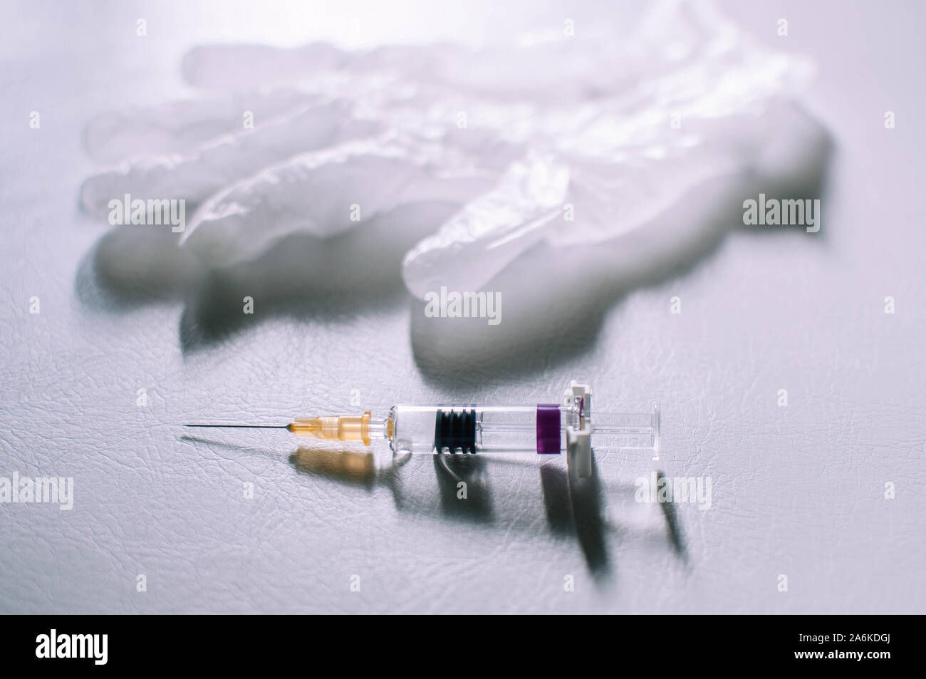Medical syringe and gloves on a white background Stock Photo - Alamy