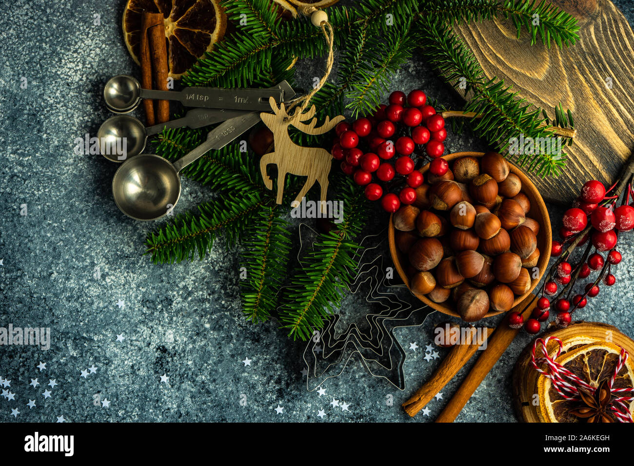 Christmas cooking background with nuts, orange, anise star and cinnamon ...