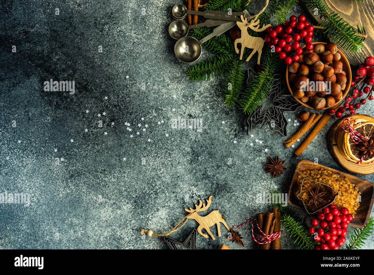 Christmas cooking background with nuts, orange, anise star and cinnamon ...