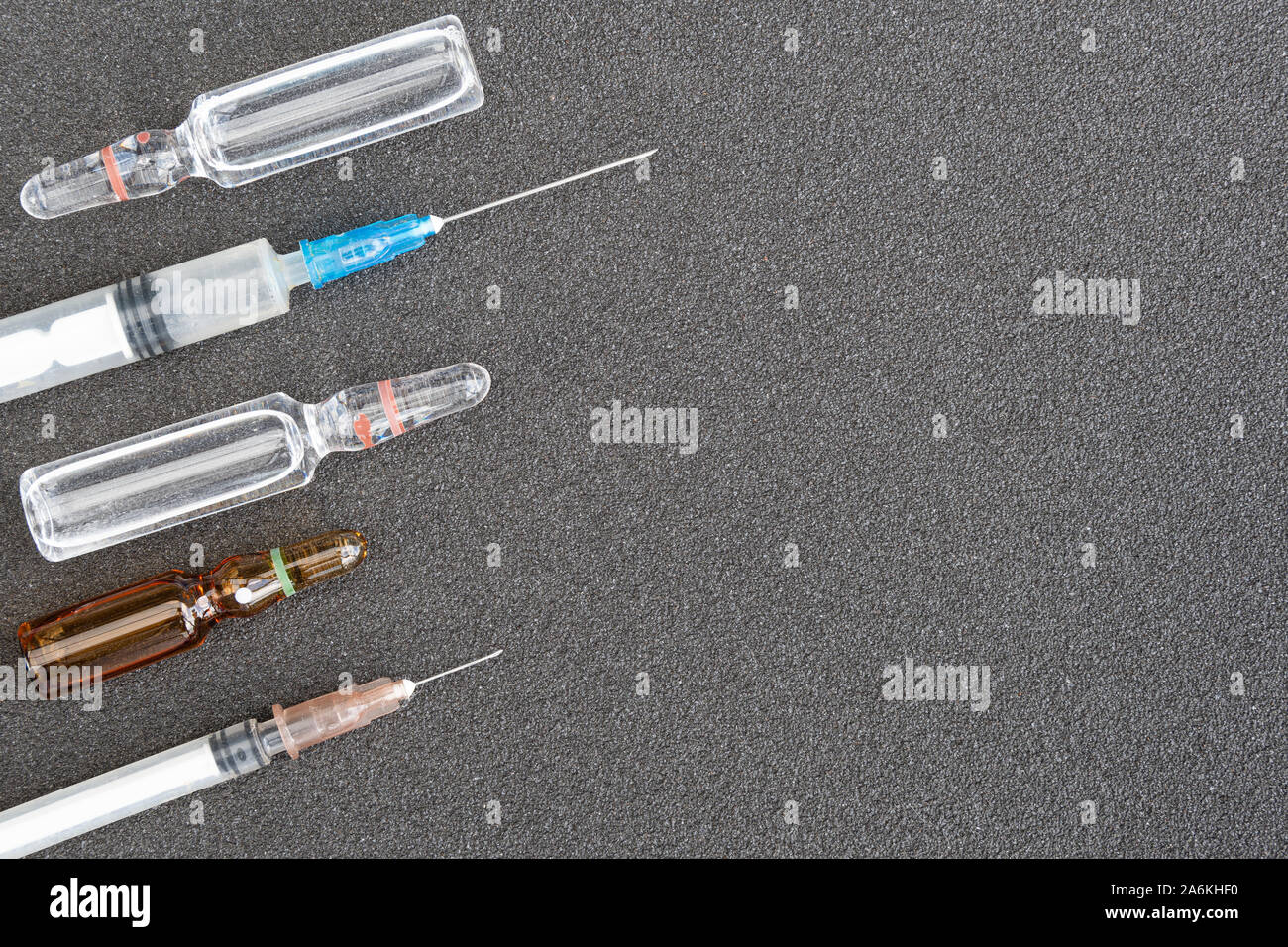 Syringes and vials of medicine on pavement. Hospital treatment ...