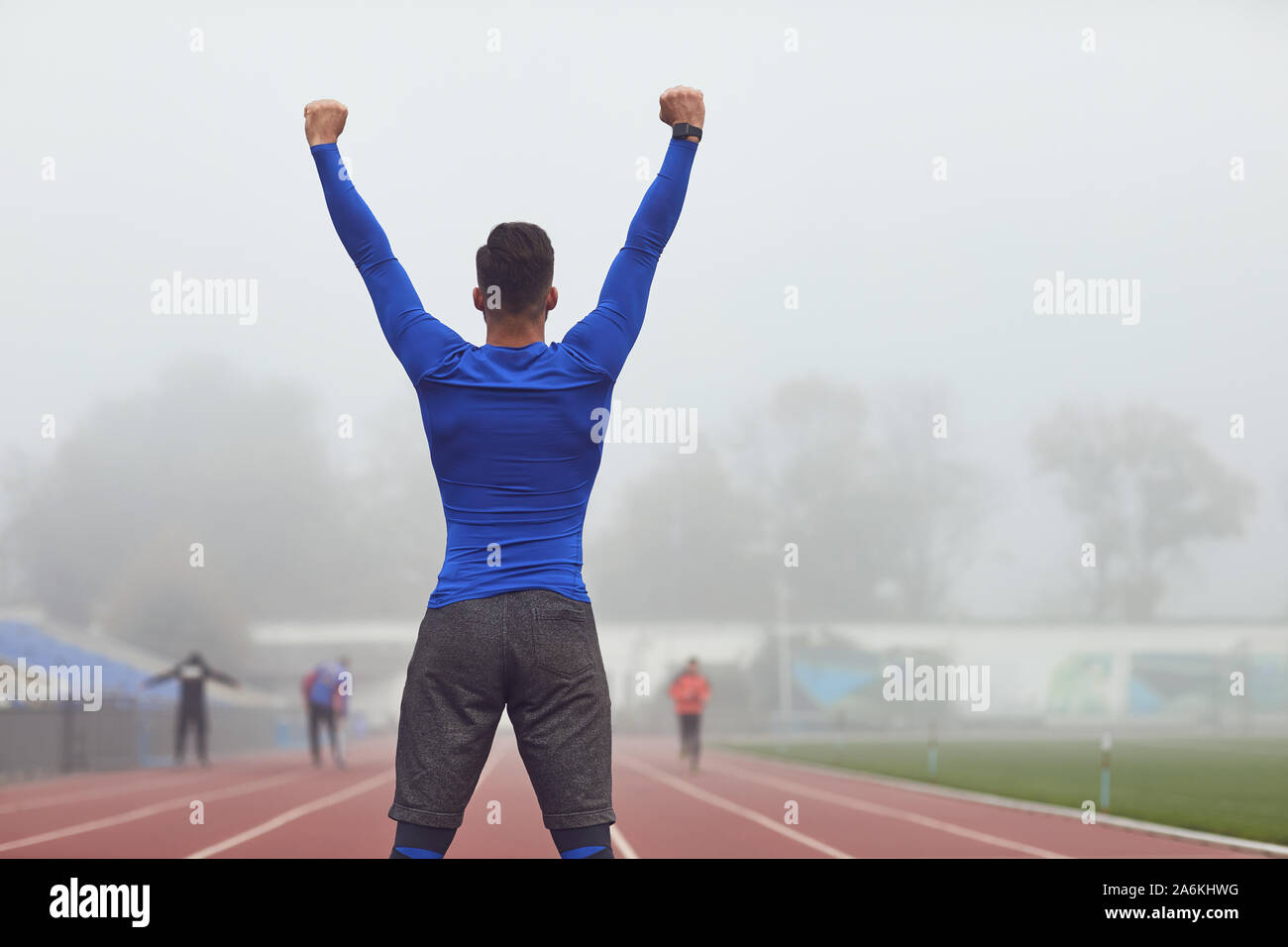 The guy the athlete raised his hands up at the stadium in the fog Stock ...