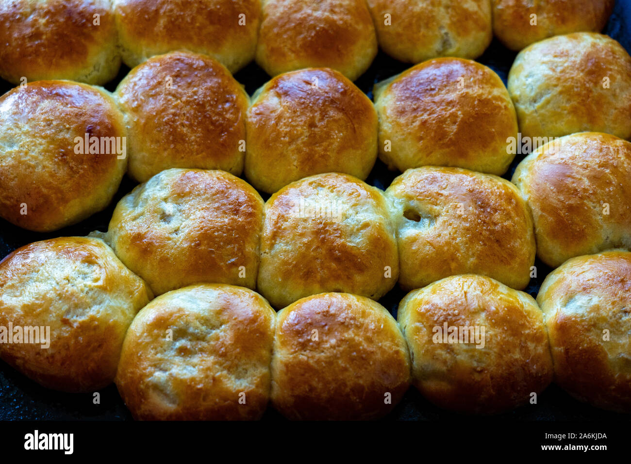 Baked hot buns. Sweet buns on a baking sheet Stock Photo - Alamy