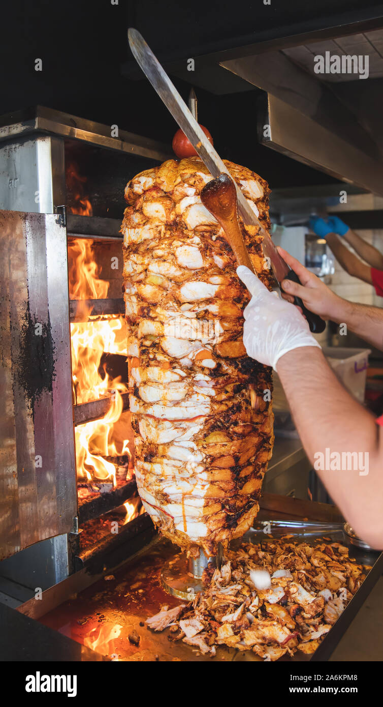 Chef cutting with doner knife Traditional Turkish Doner Kebab meat ...
