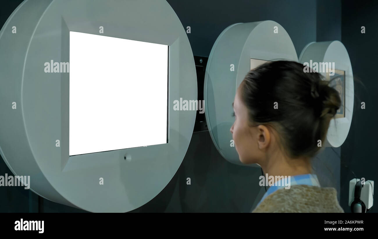Woman looking at blank white display wall at exhibition - white screen ...