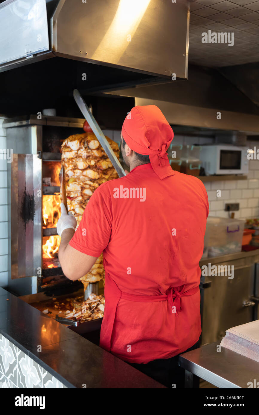Chef cutting with doner knife Traditional Turkish Doner Kebab meat ...