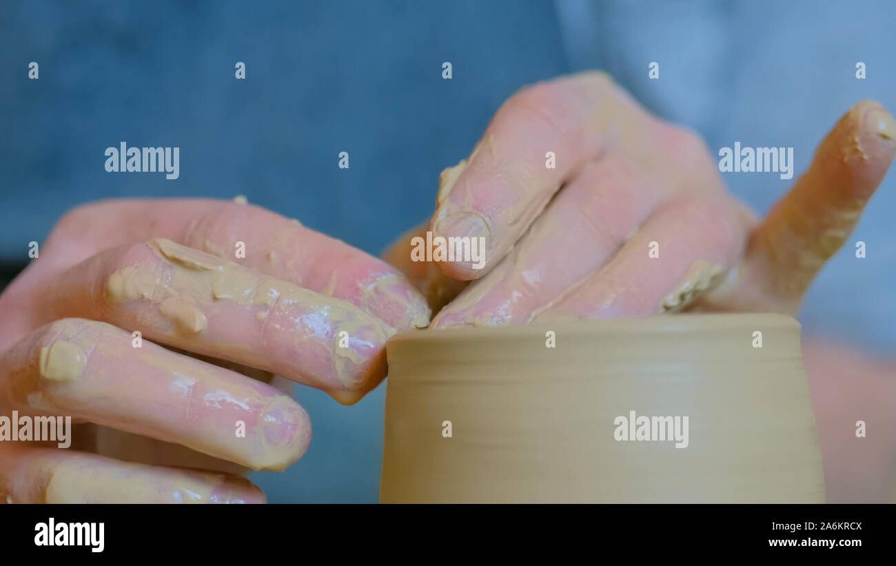 Professional potter shaping pot in pottery workshop Stock Photo - Alamy