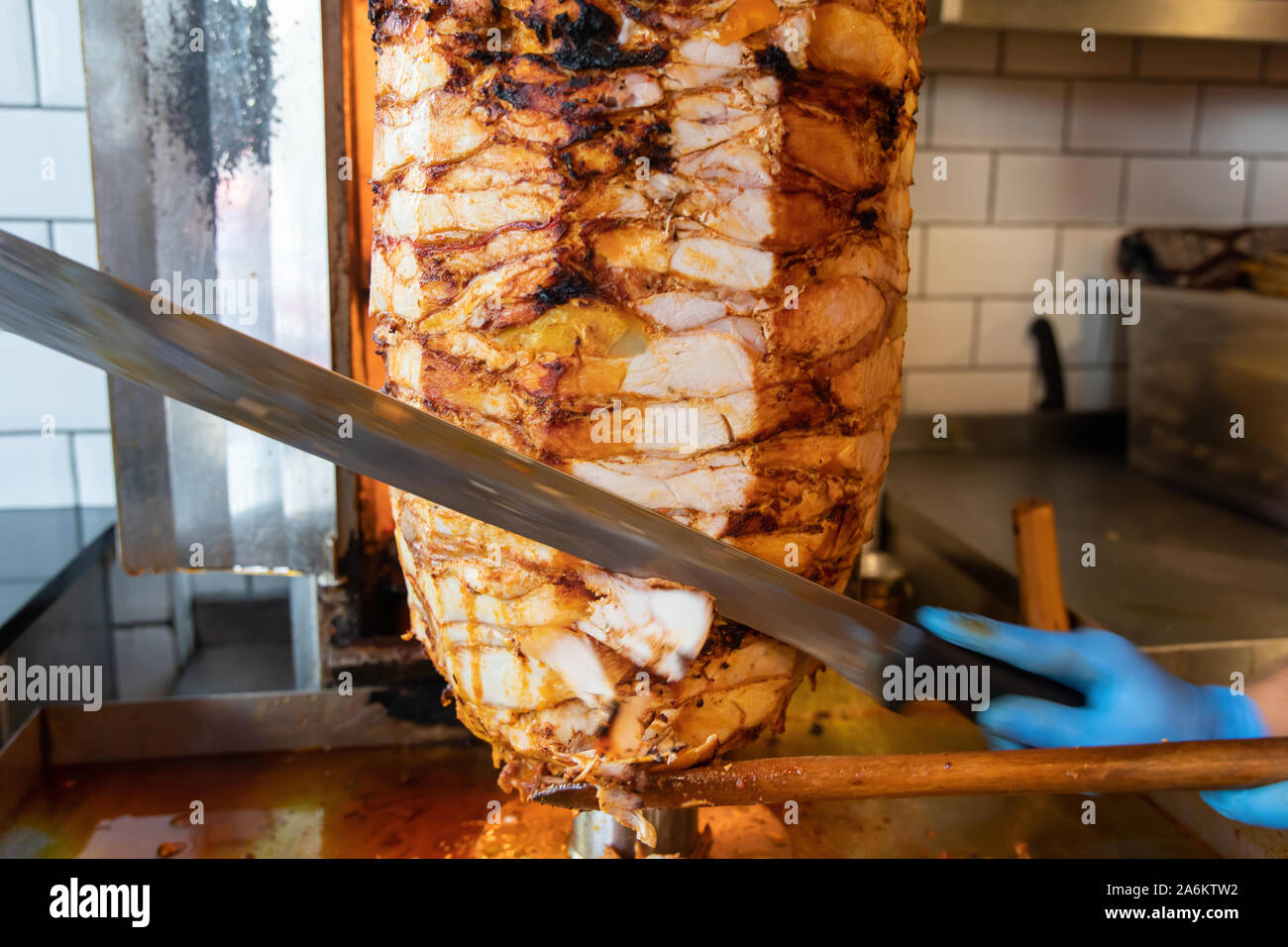 Chef cutting with doner knife Traditional Turkish Doner Kebab meat ...