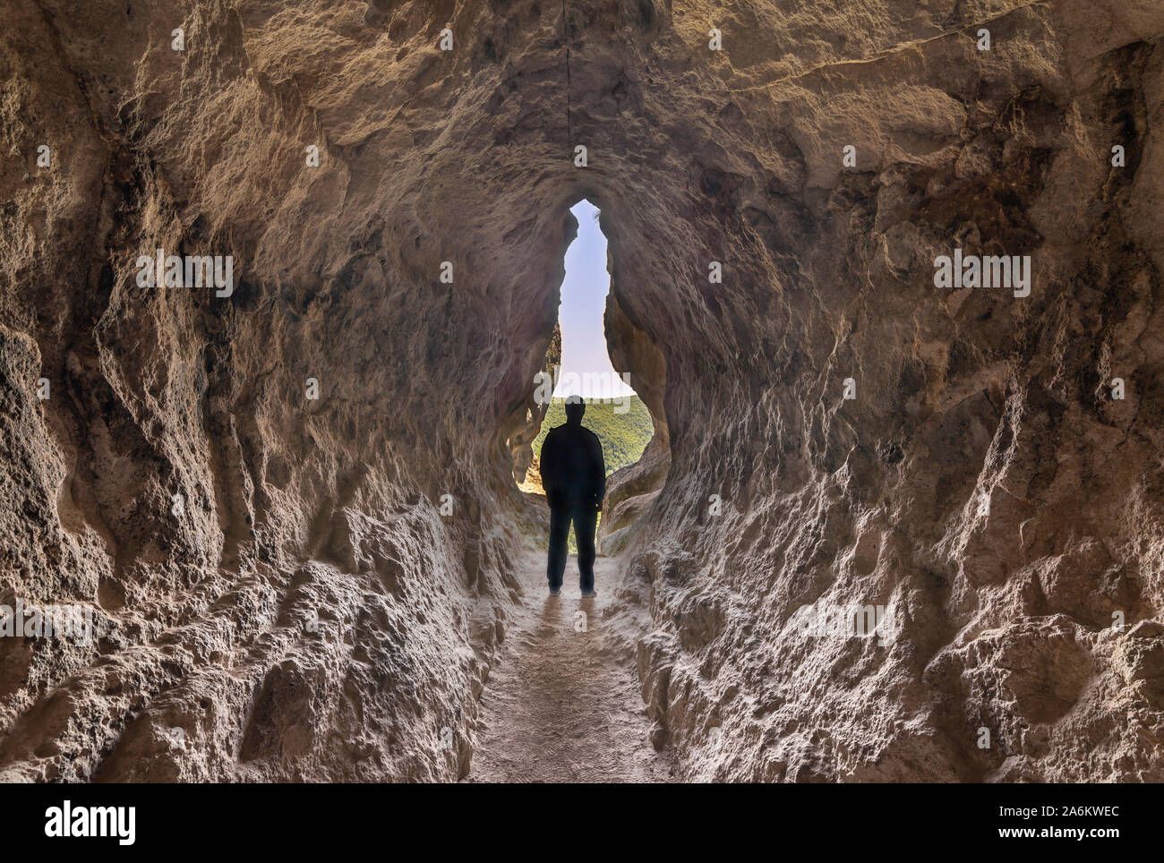 Human birth and light at the end of the tunnel concept. Man standing at ...
