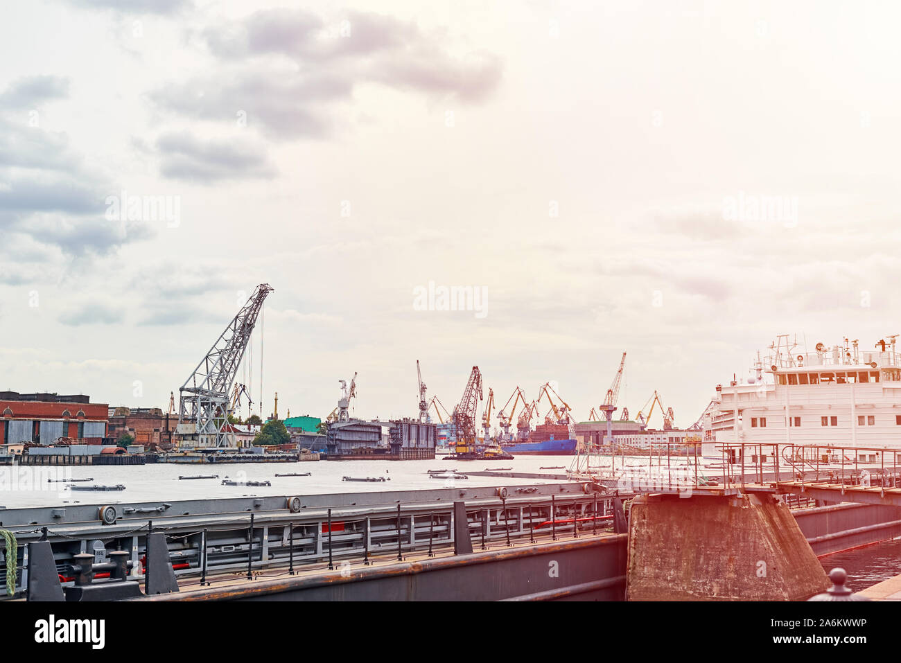 working crane bridge in shipyard and cargo ships in port Stock Photo ...