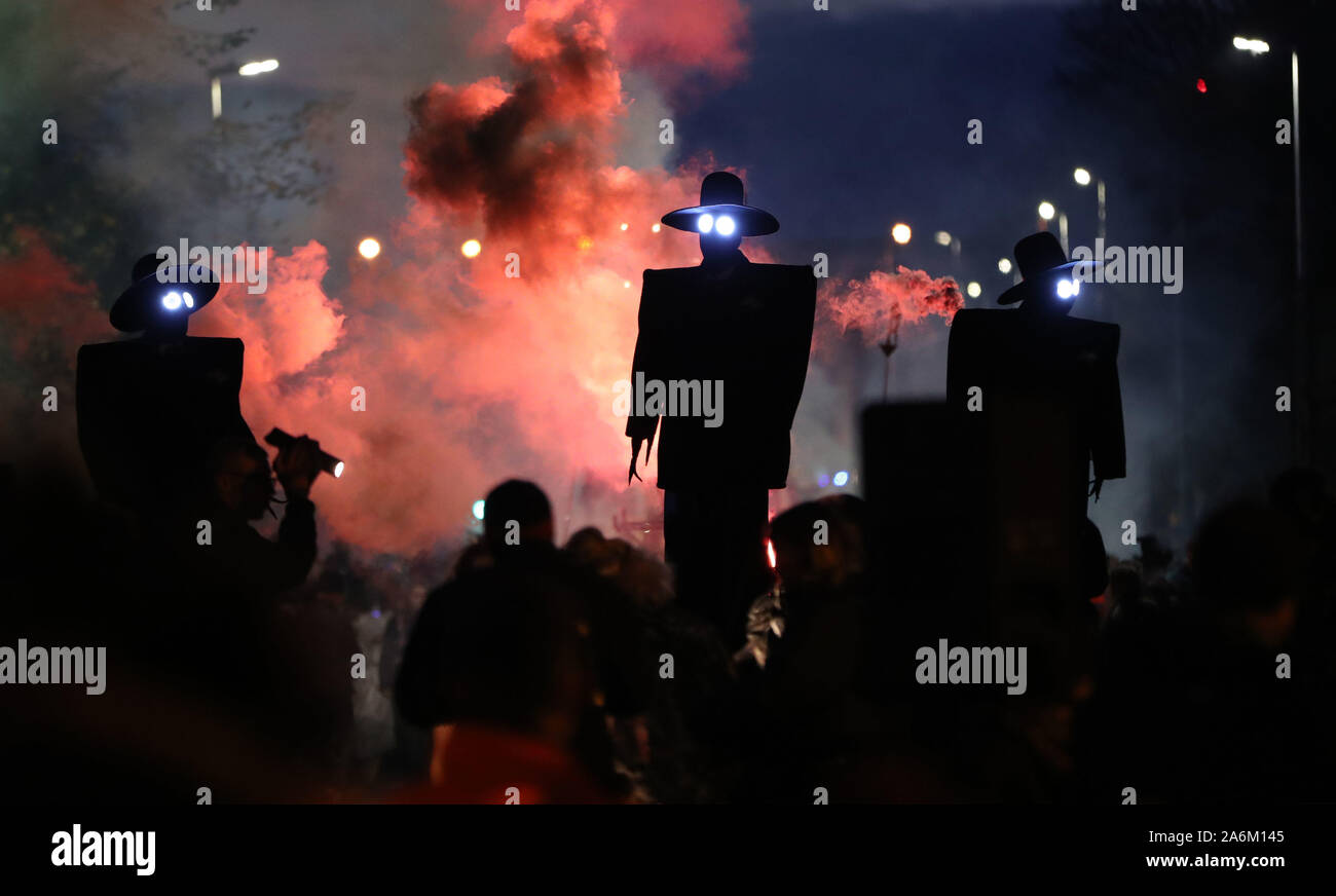 Crowds watch the Macnas Halloween Parade making its way through Galway ...