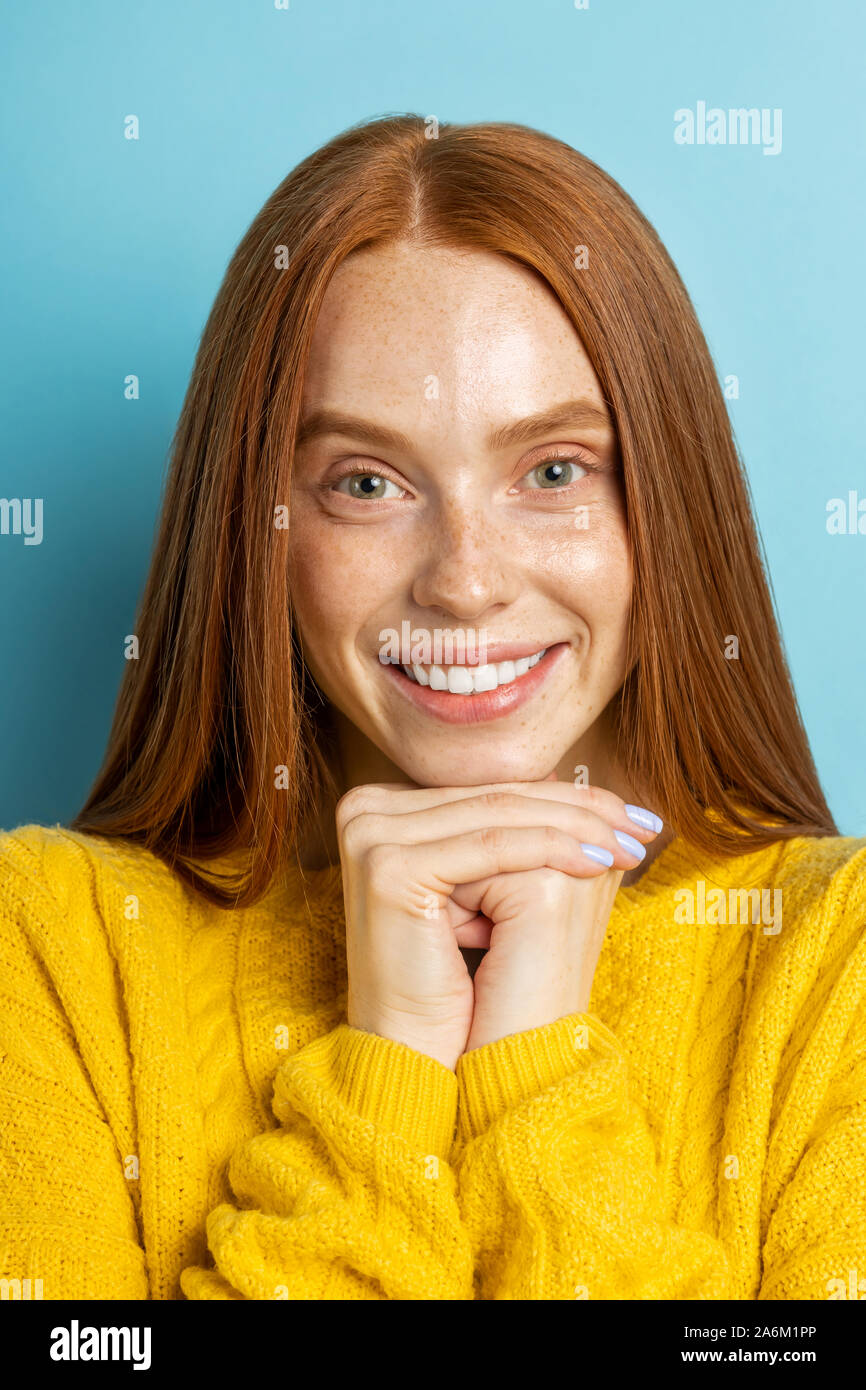 Vertical closeup portrait of cheerful ginger young woman with freckled ...