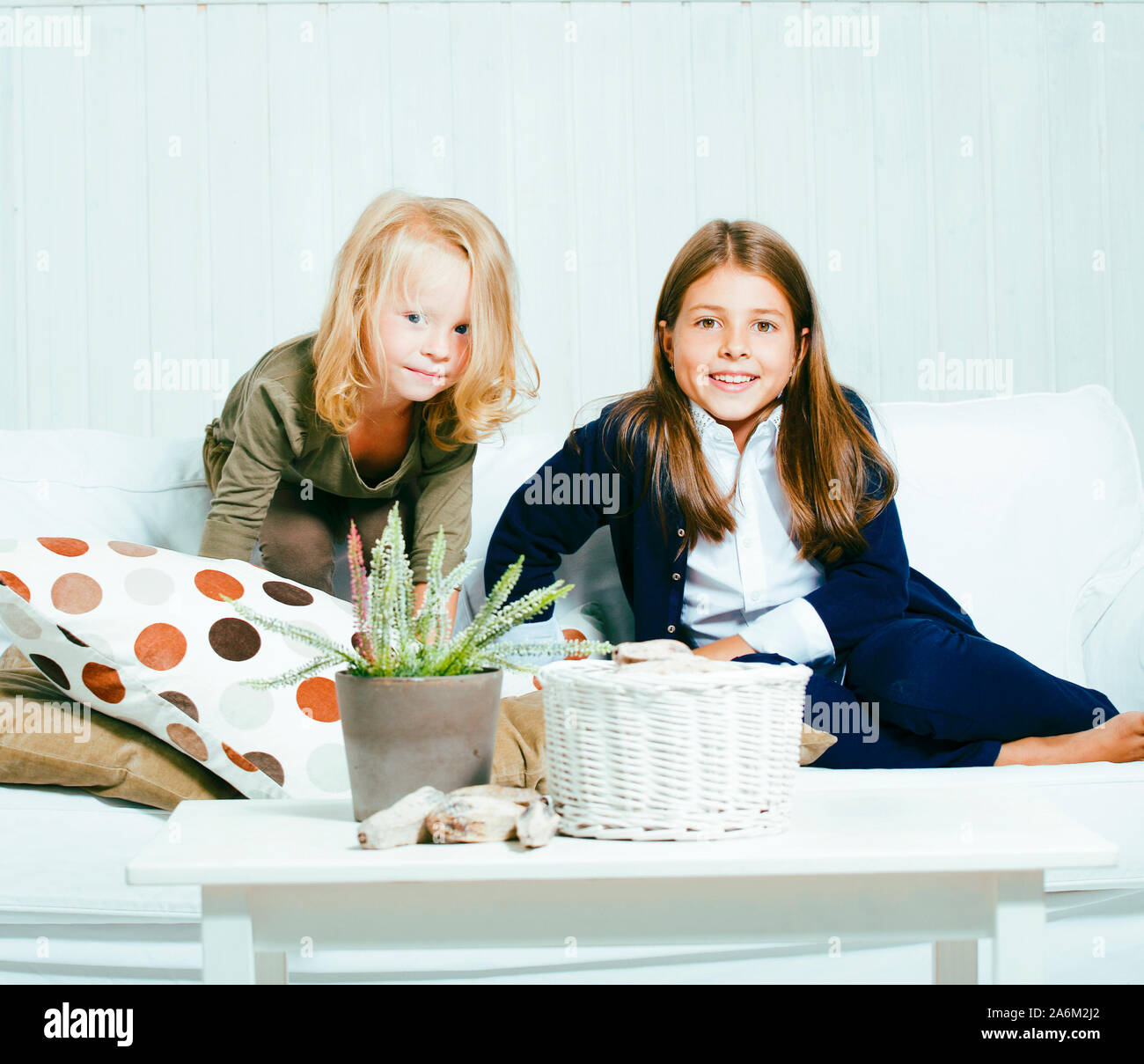 two cute sisters at home playing, little smiling girl in house interior ...