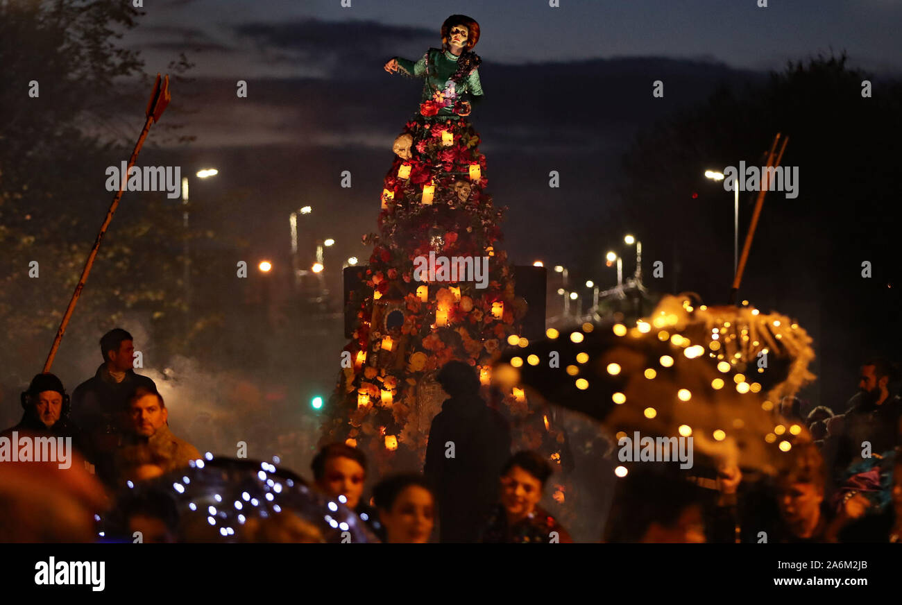 Crowds watch the Macnas Halloween Parade making its way through Galway ...