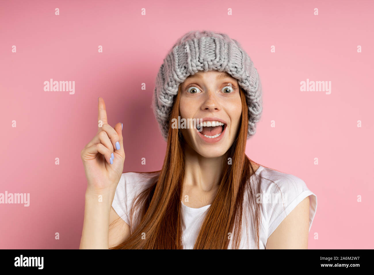 Astonished Female With Long Ginger Hair Freckles Pointing Upwards With