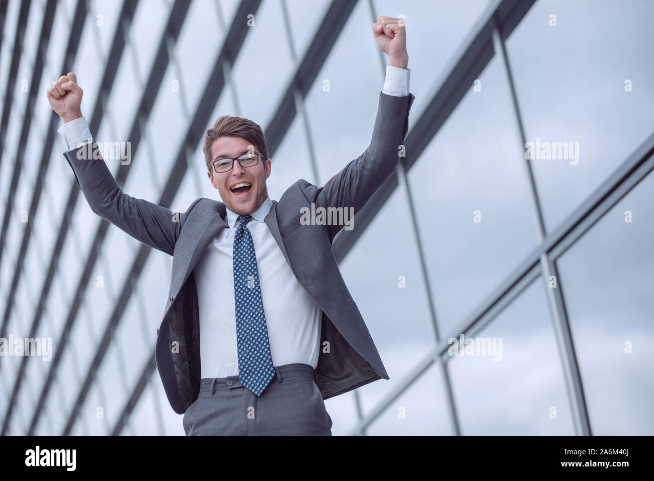 jubilant business man on the background of an office building Stock ...