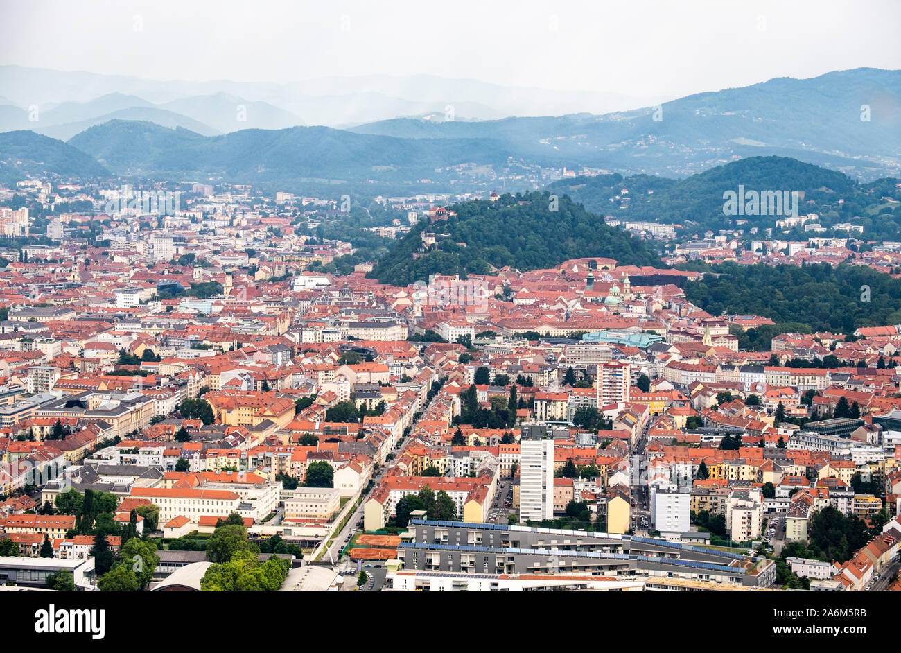 Aerial view of center city Graz from helicopter drone with hill ...