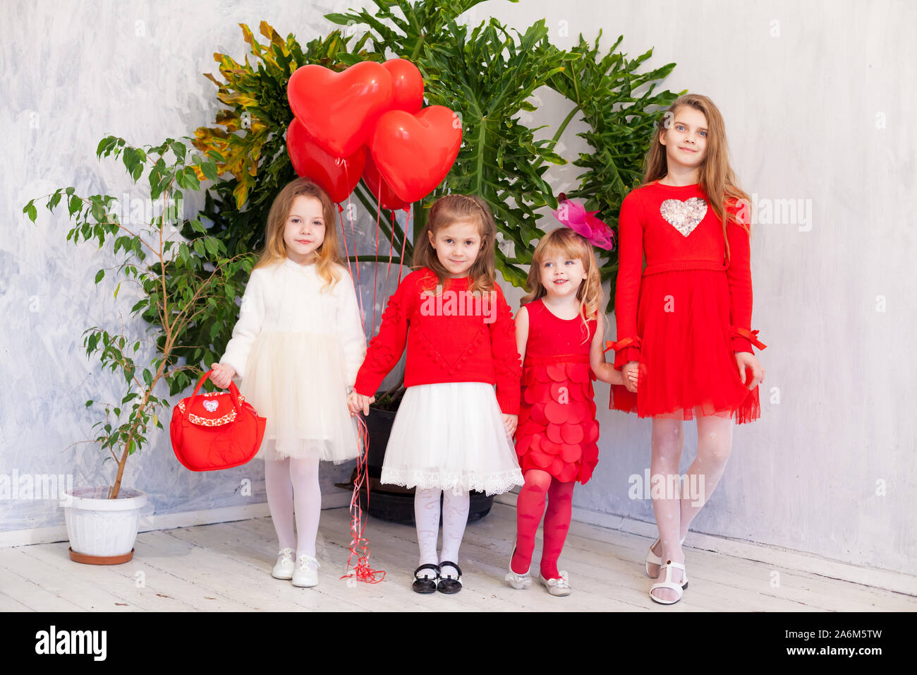 Kids with red balloons for birthday in the interior Stock Photo - Alamy