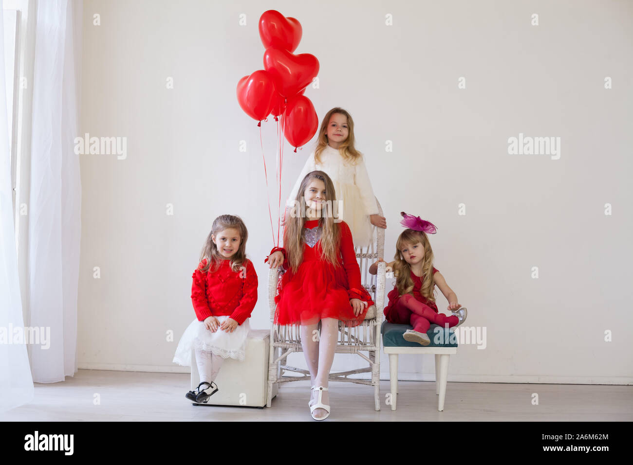Kids with red balloons for birthday in the interior Stock Photo - Alamy