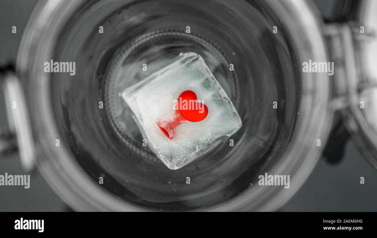 Red elastic rubber heart frozen in an ice cube melting in the sun Stock ...