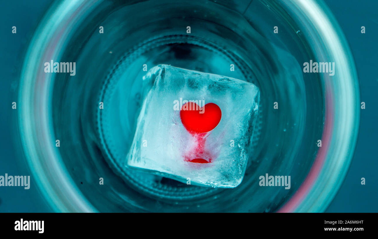 Red elastic rubber heart frozen in an ice cube melting in the sun Stock ...