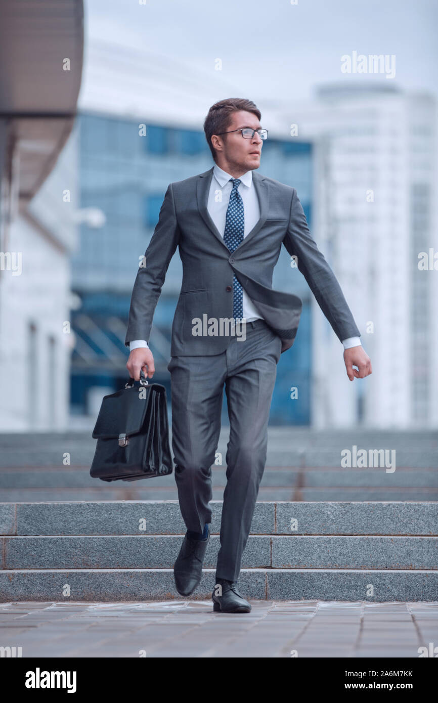 serious business man walking on city street Stock Photo - Alamy