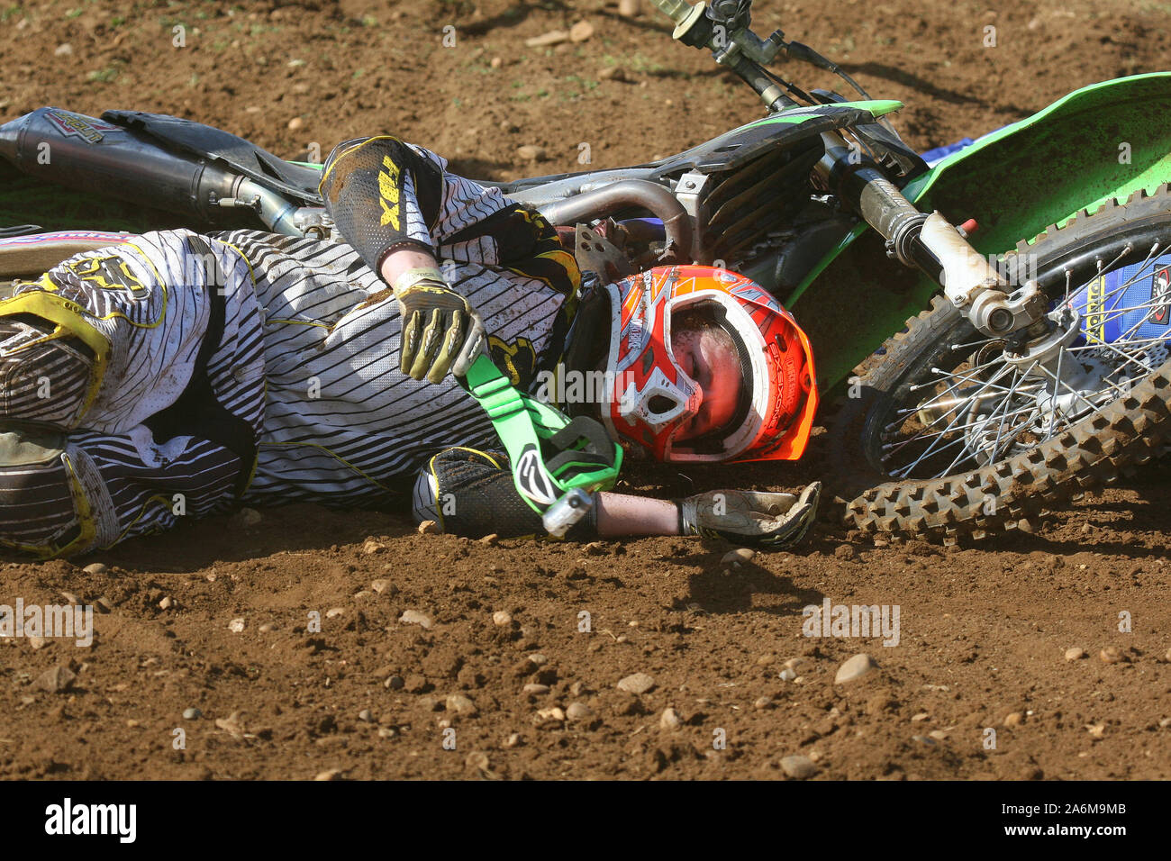 Injured motocross rider laying on the race track Stock Photo - Alamy