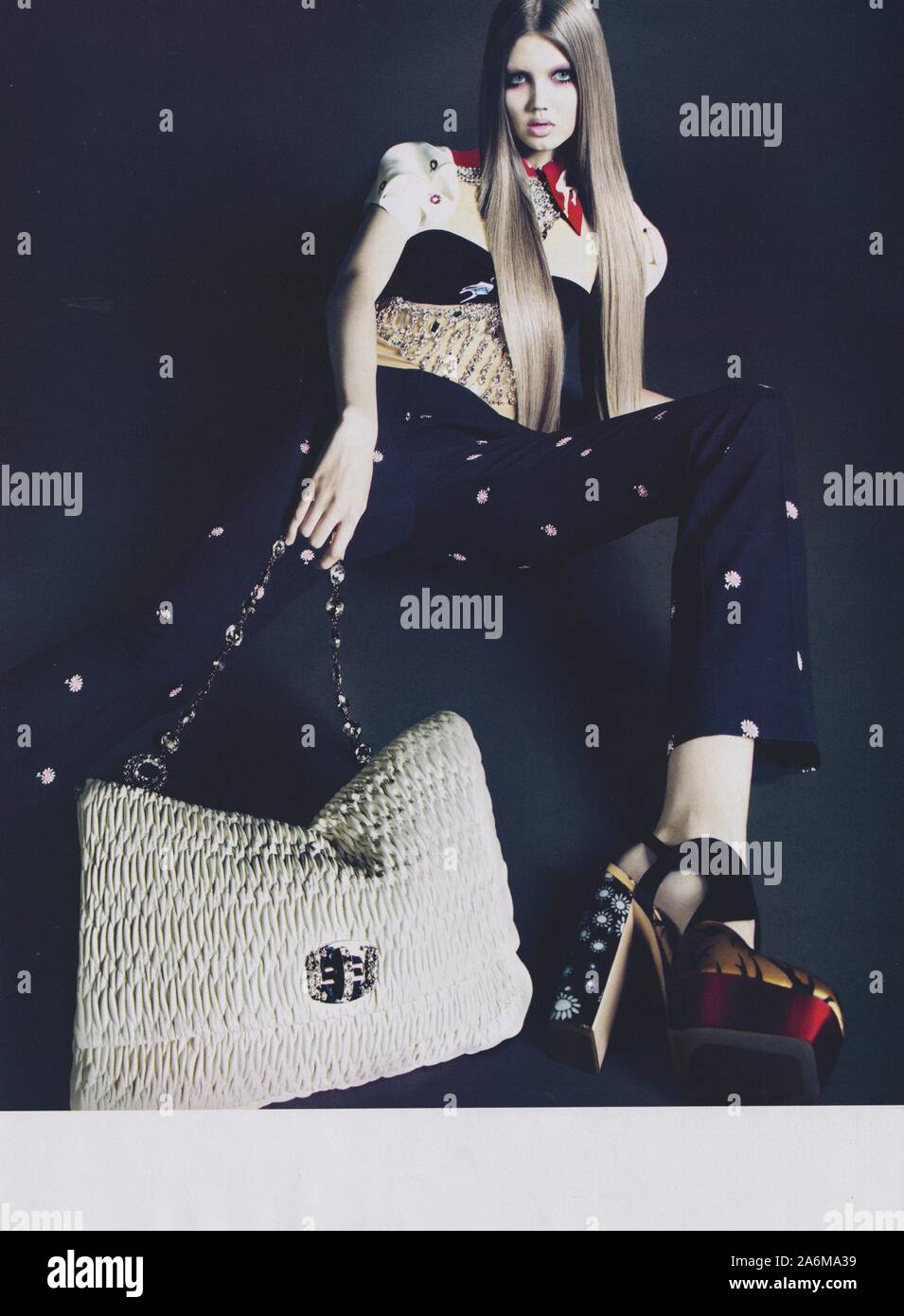 poster advertising Miu Miu fashion house with Lindsey Wixson in paper ...