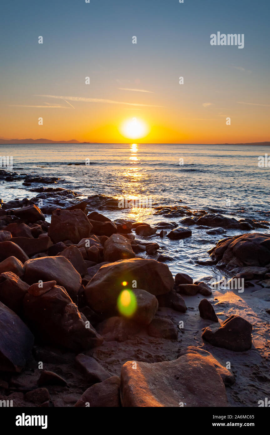 Scenic rocky beach Cala Violina landscape at the sunset. The sun is ...