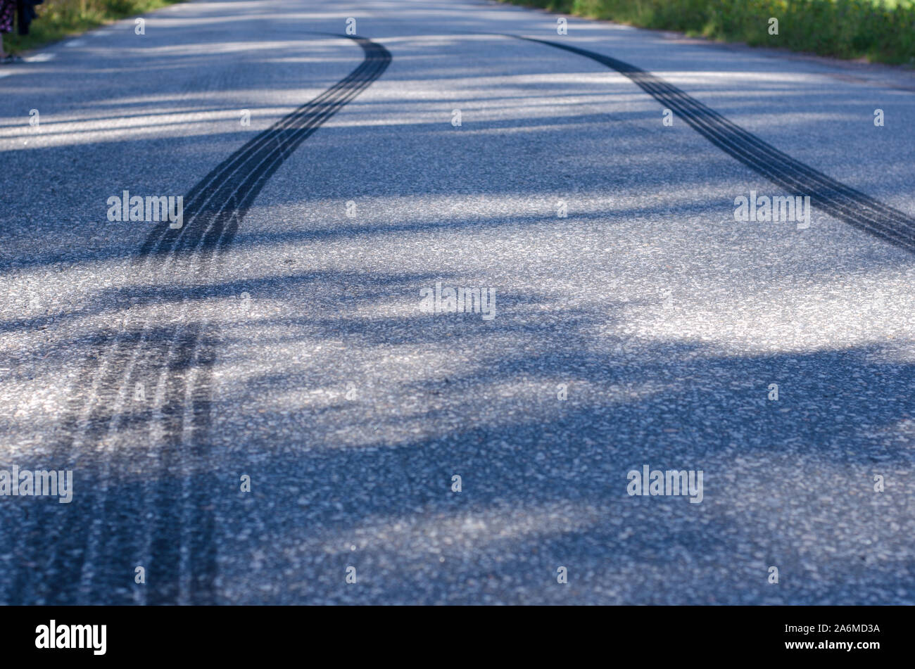 Skidmarks after a sudden braking on a narrow road with asphalt surface ...