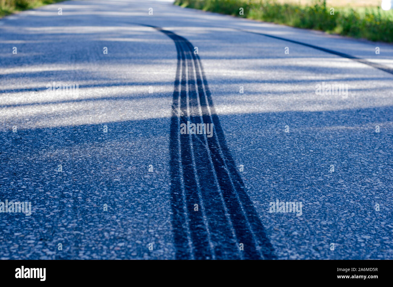 Skidmarks after a sudden braking on a narrow road with asphalt surface ...