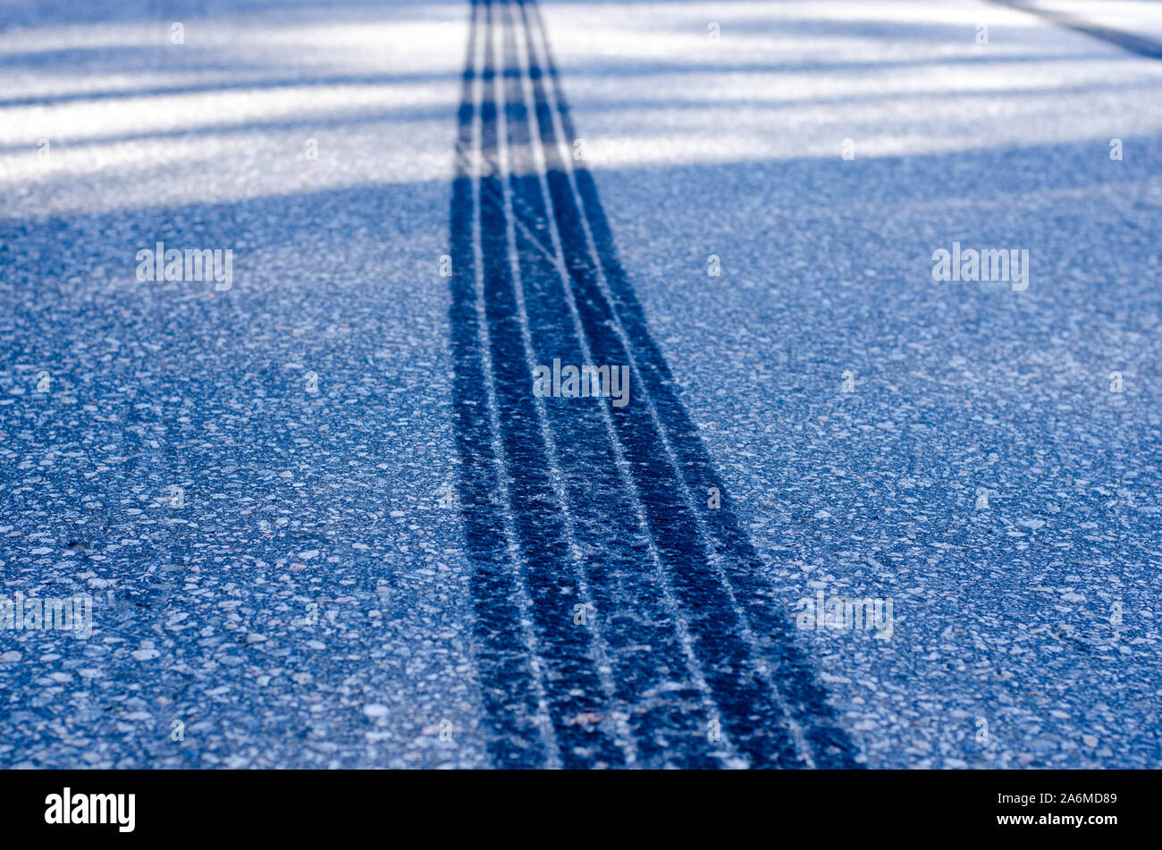Skidmarks after a sudden braking on a narrow road with asphalt surface ...