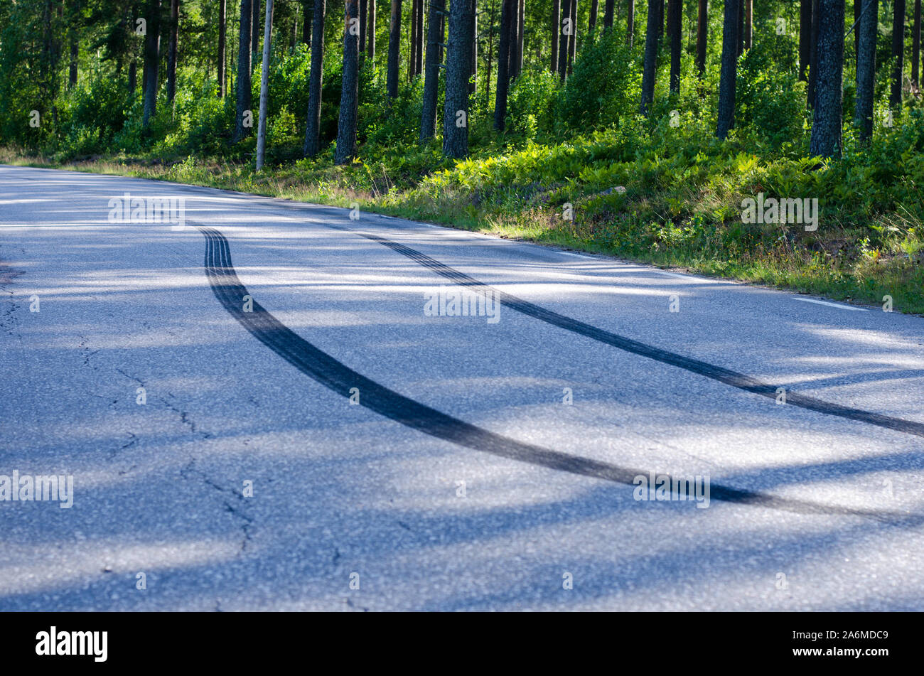Skidmarks after a sudden braking on a narrow road with asphalt surface ...