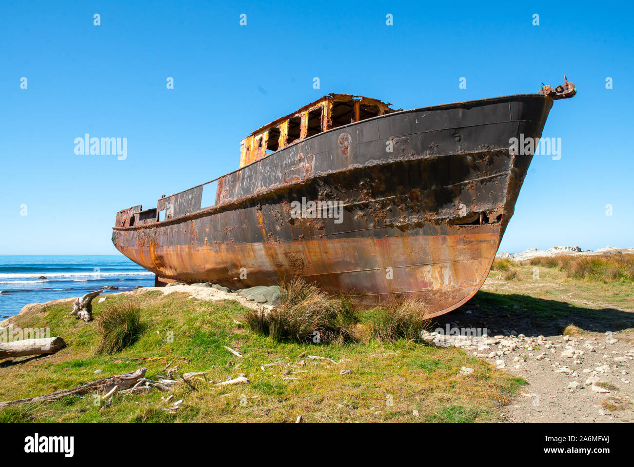 Abandoned rusty shell of the old shipwreck Magnet beached on Wairarapa ...