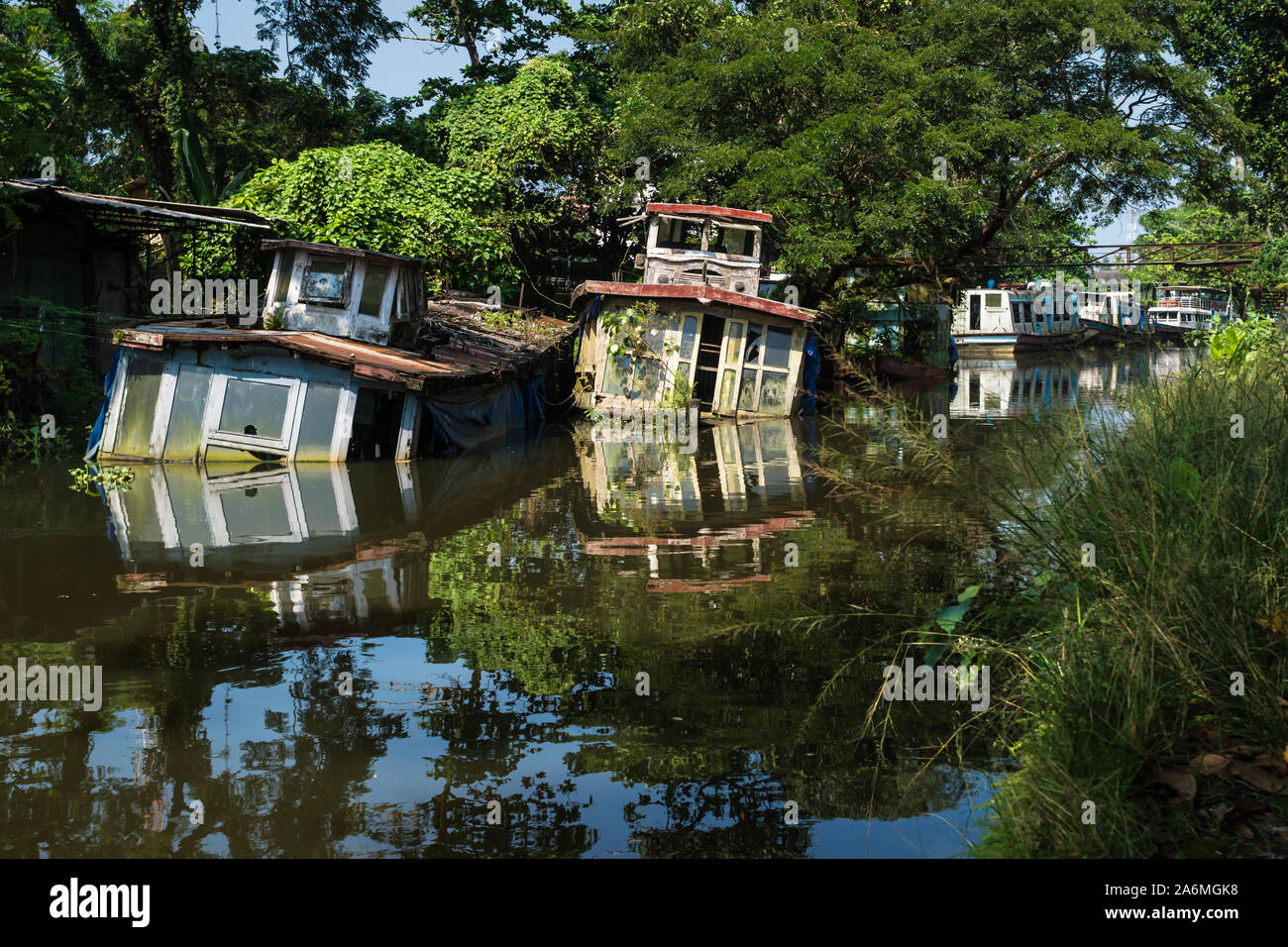 Sunken house boats with reflections in the water in Kerala backwater ...