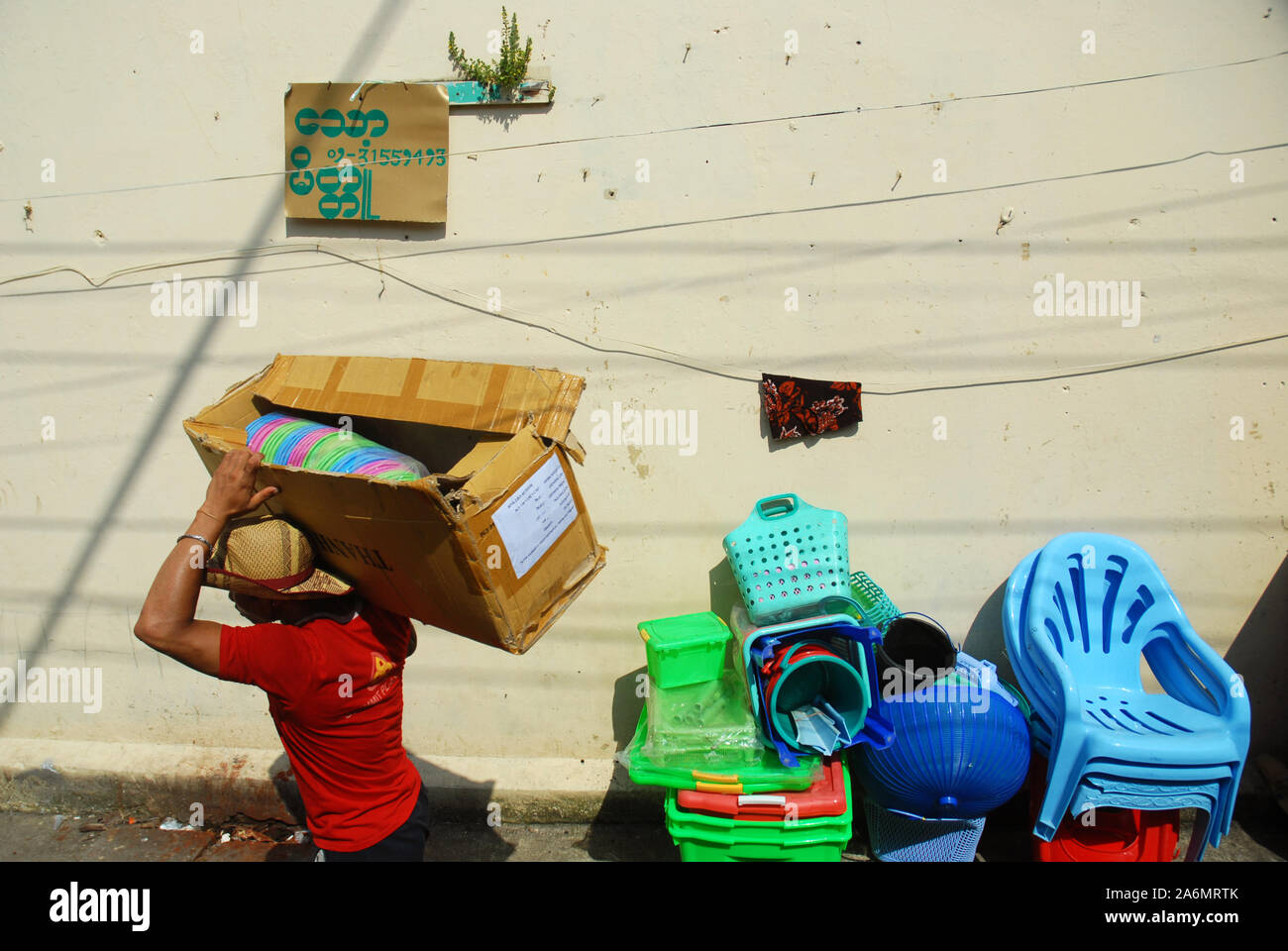 Man carrying plastic containers hi-res stock photography and images - Alamy