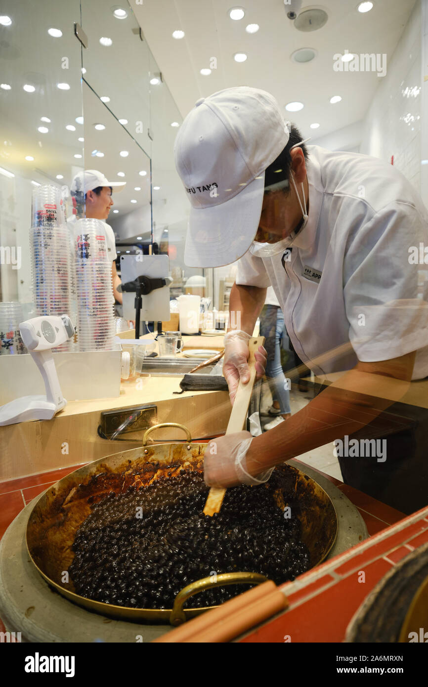 Cooking brown sugar boba at the bubble tea shop Xing Fu Tang in ...