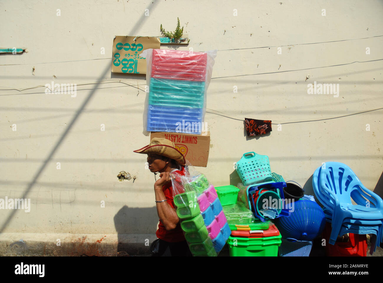 Man carrying plastic containers hi-res stock photography and images - Alamy