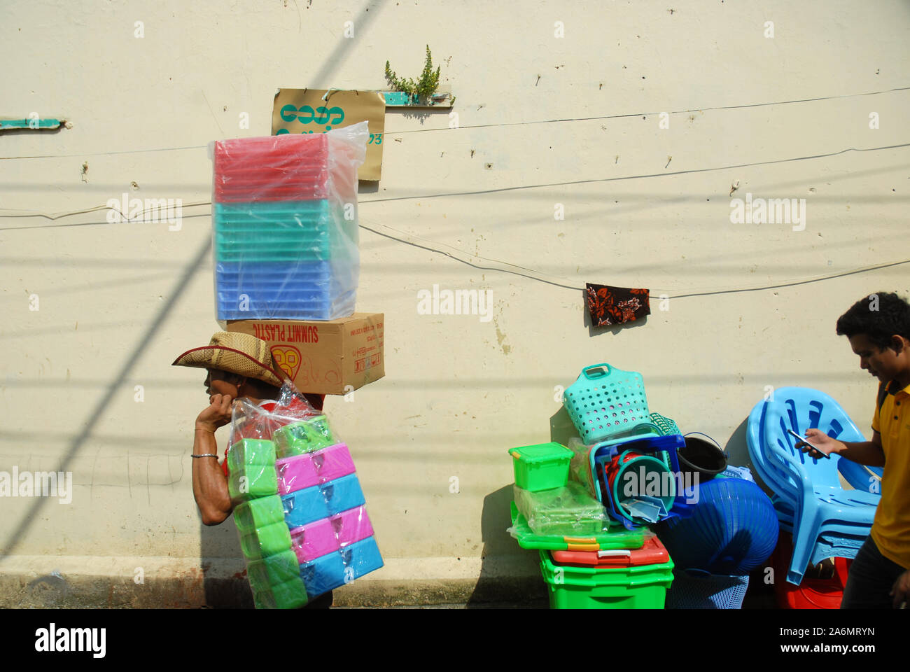 Man carrying plastic containers hi-res stock photography and images - Alamy