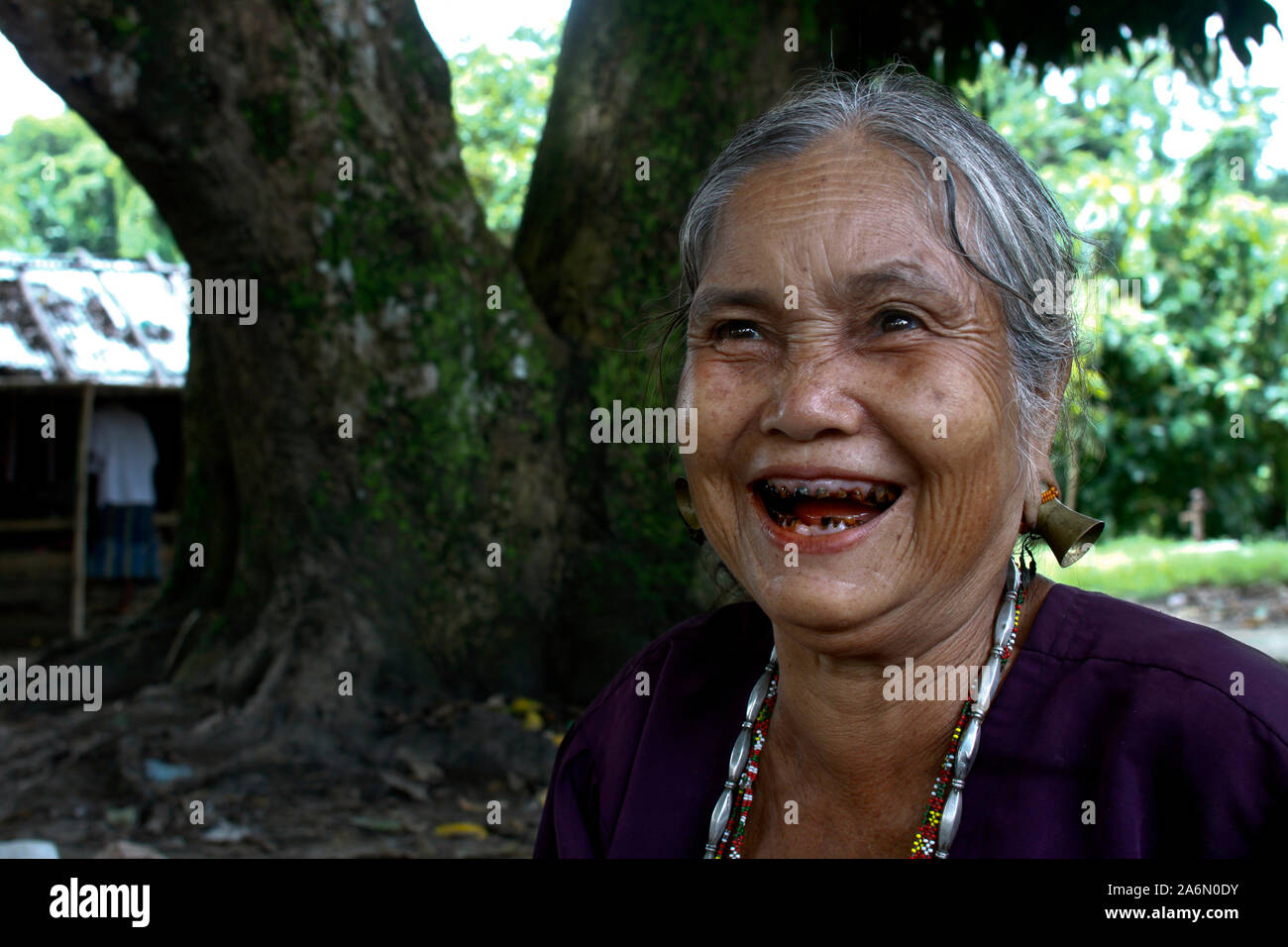 A smiling elderly woman from the ethnic Murong (also known as Mro or ...
