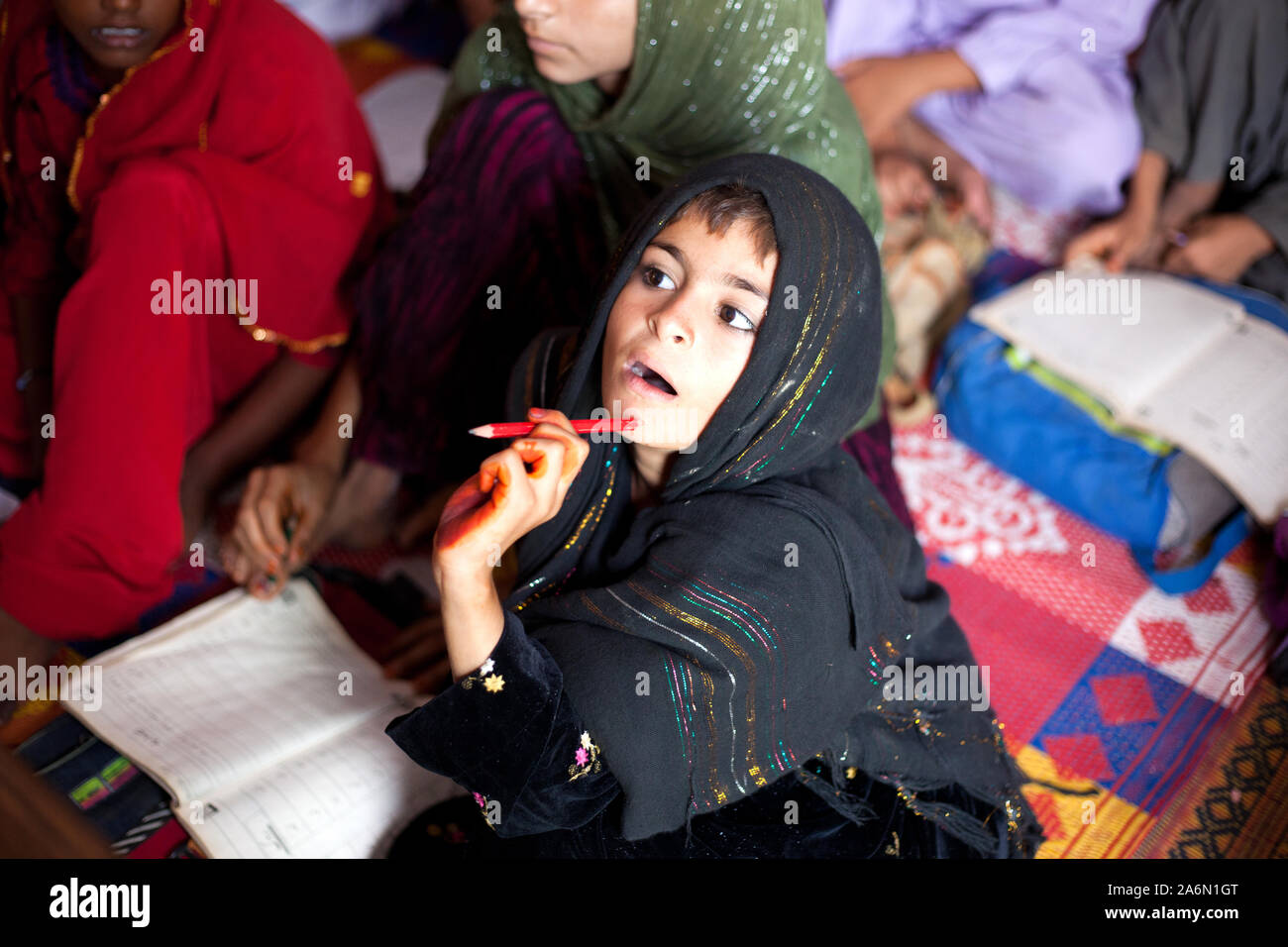 An Afghan Refugee child thinks about the lesson being taught to her in ...